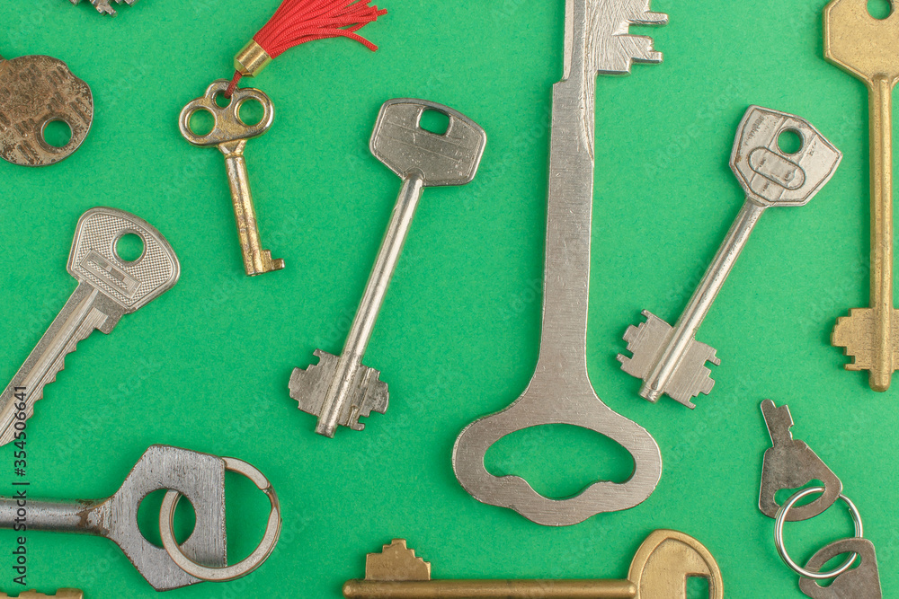Background made from different metal keys on the green base Stock Photo ...