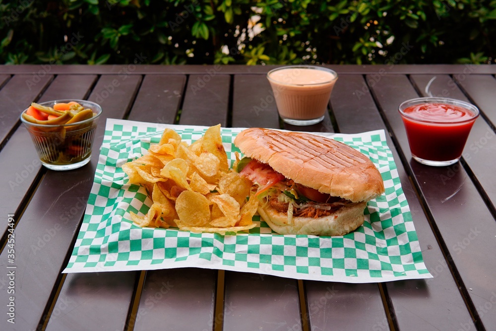 Mexican torta, souces and chips with garnishes Stock Photo | Adobe Stock