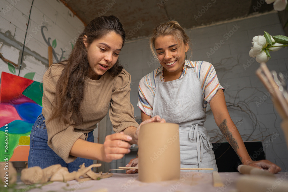 Individual masterclass of ceramics. Two beautiful woman in the pottery ...