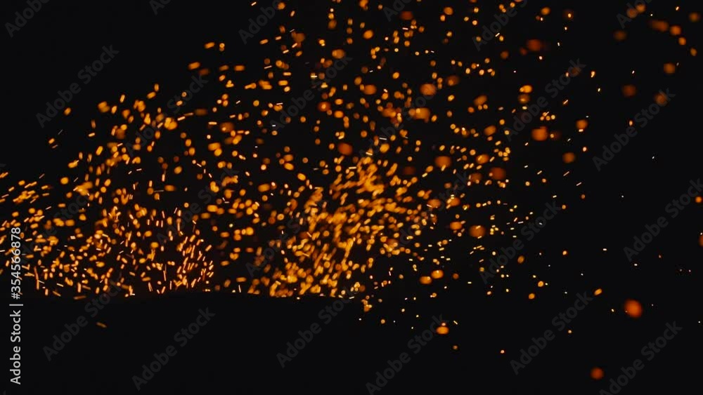 Sparks from bonfire over dark night environment, shallow focus. Burning ...