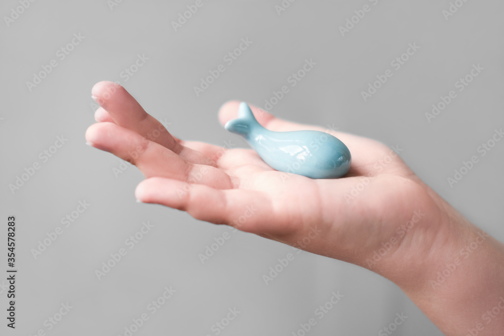 human hand holding blue whale. save whales and protect nature. eco ...