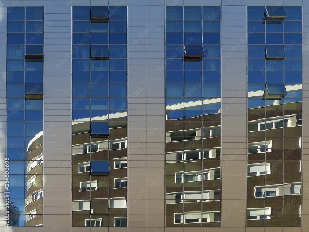 Modern glass building with reflection of other building Stock Photo ...