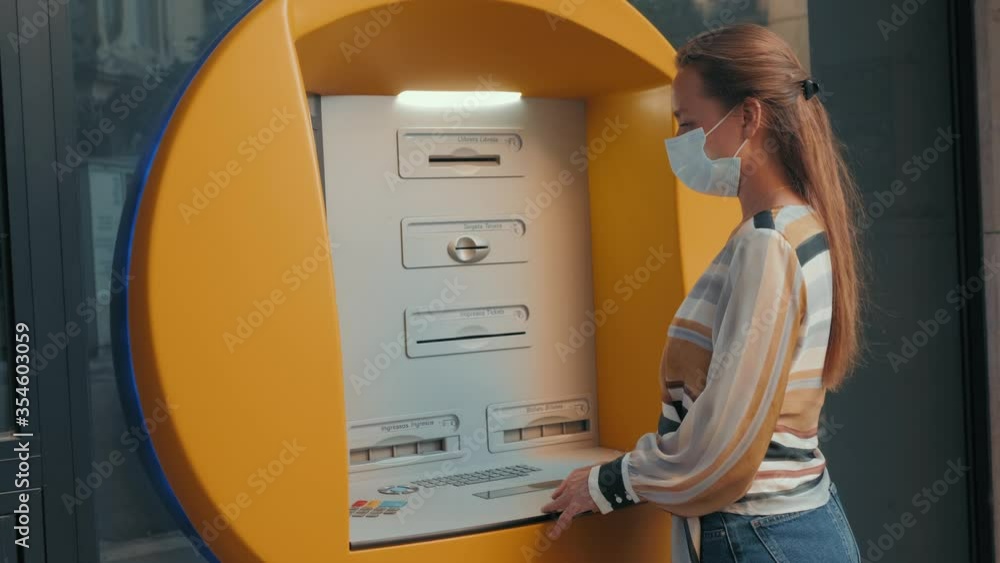 Woman wearing medical mask for prevent infection coronavirus using ATM ...