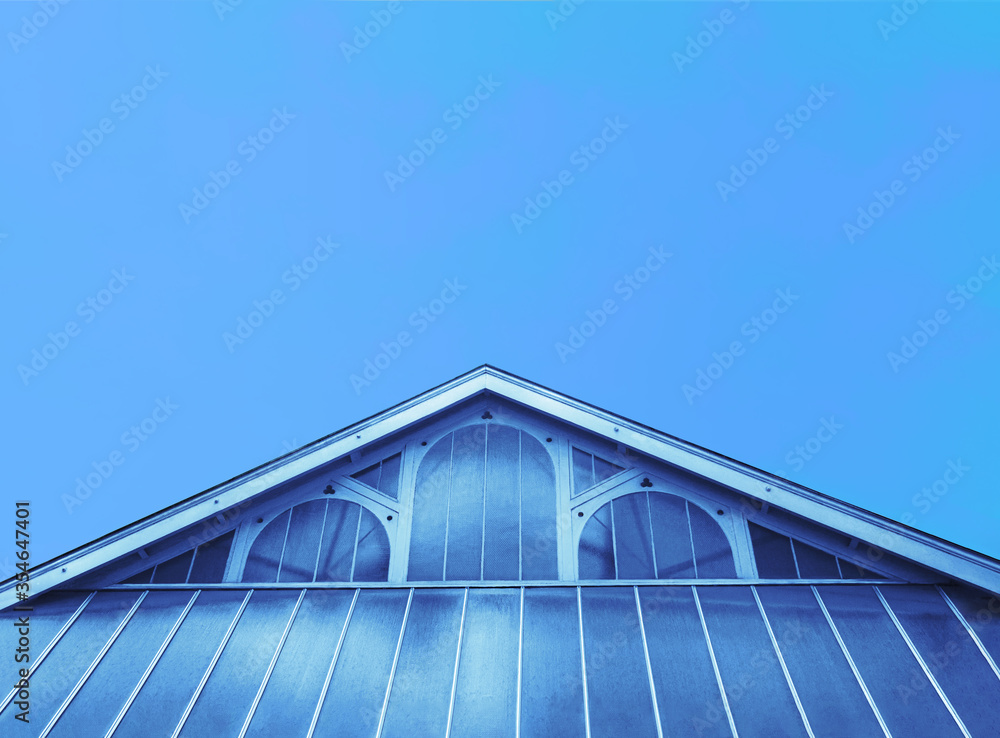 Blue roof windows on a cloudless blue sky. Frontal view of an isolated ...