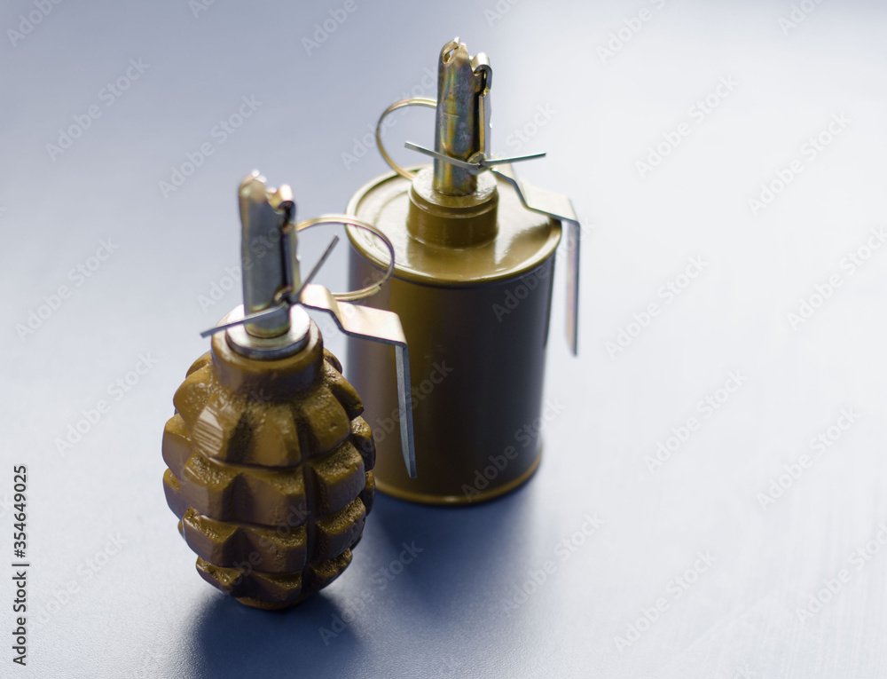 Hand grenades on a gray background. Explosive ammunition is designed to ...