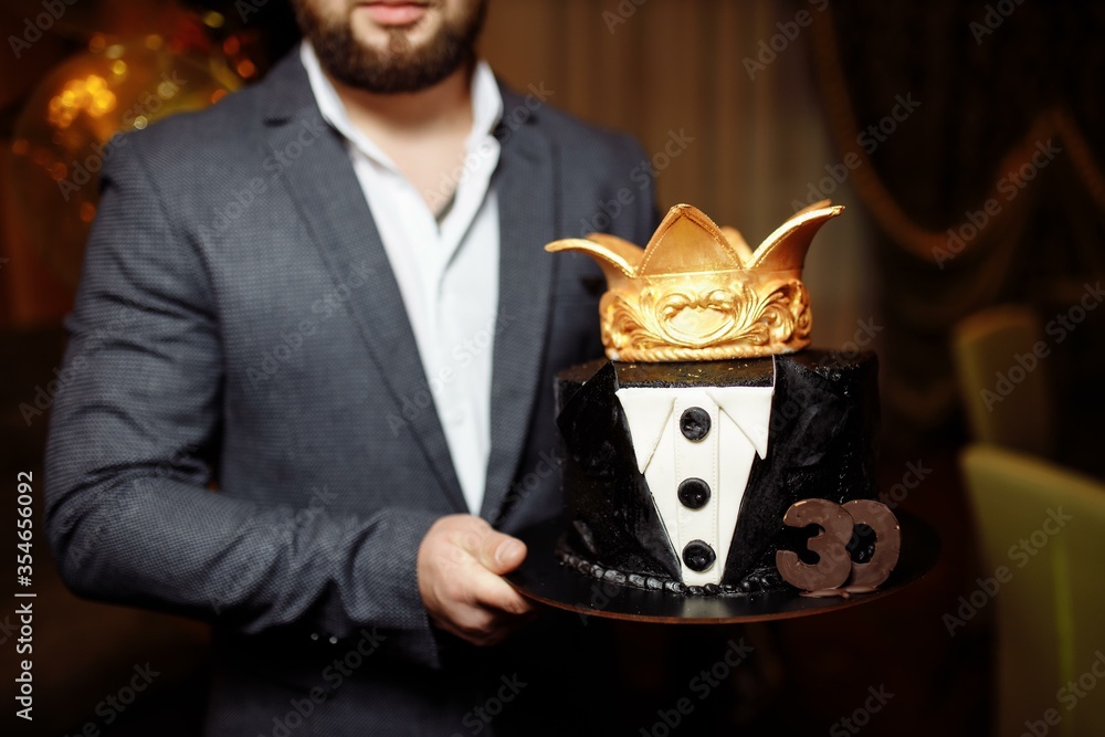 Beautiful cake for men, decorated in the form of a suit. The concept of ...