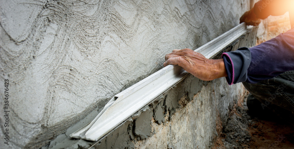 Construction workers in industrial buildings are plastering to build ...
