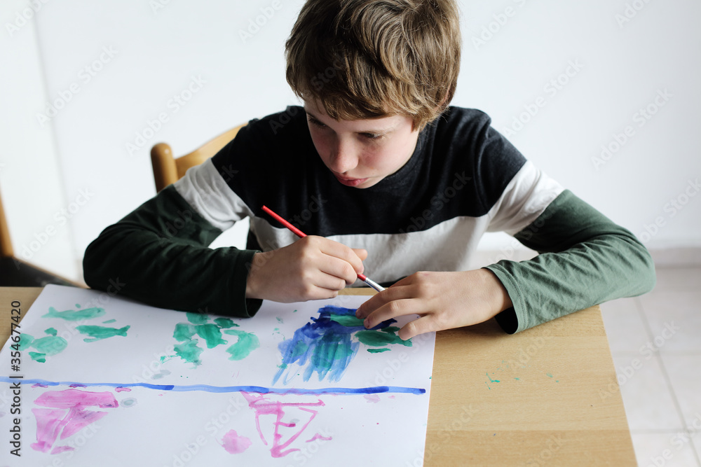 Cute 12 years old autistic boy drawing Stock Photo | Adobe Stock