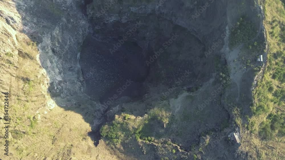 Top down view of a deep hole with rocks landslides caused by an ...