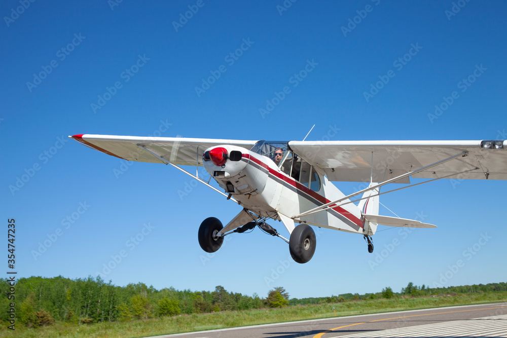Small single engine airplane takes off from a municipal airfield in ...