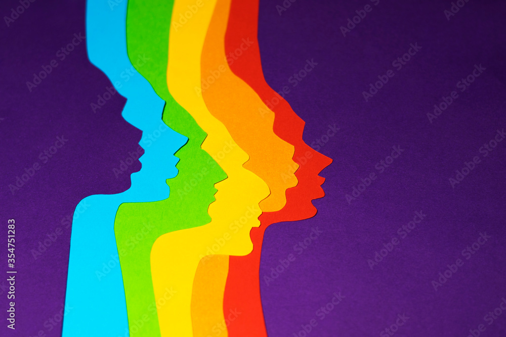The human rainbow colored profiles are cut out of paper on a purple ...