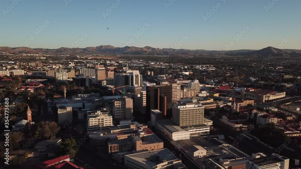 4K aerial afternoon video of savanna hills, Windhoek central business district, residential ...