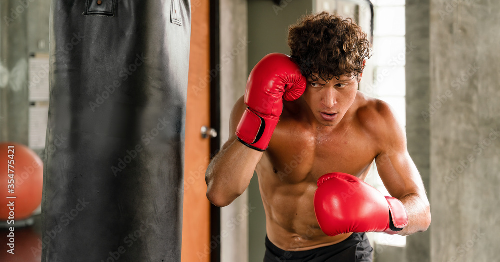 boxer workout and training boxing by punching with sand bag in gym ...