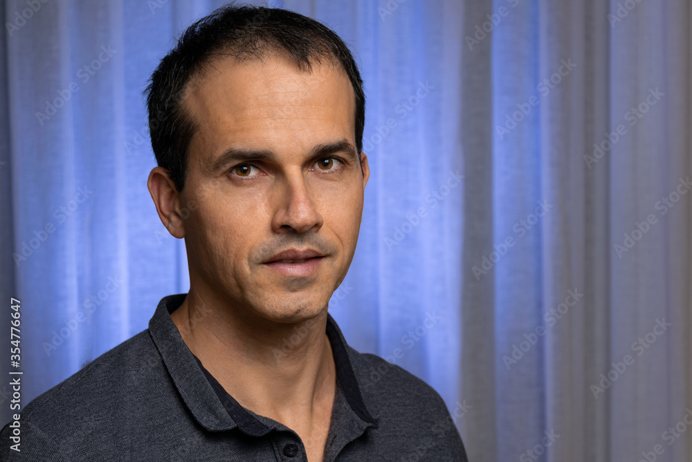 44 year old mature man with blue curtain background (flash with blue ...