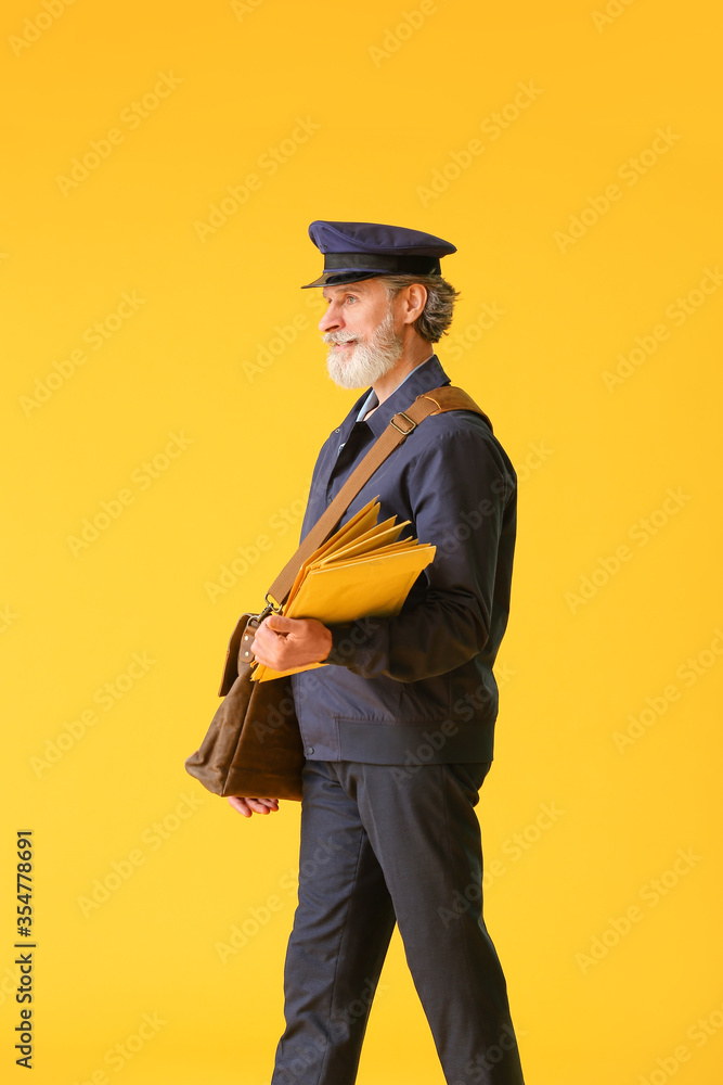Handsome old postman on color background Stock Photo | Adobe Stock
