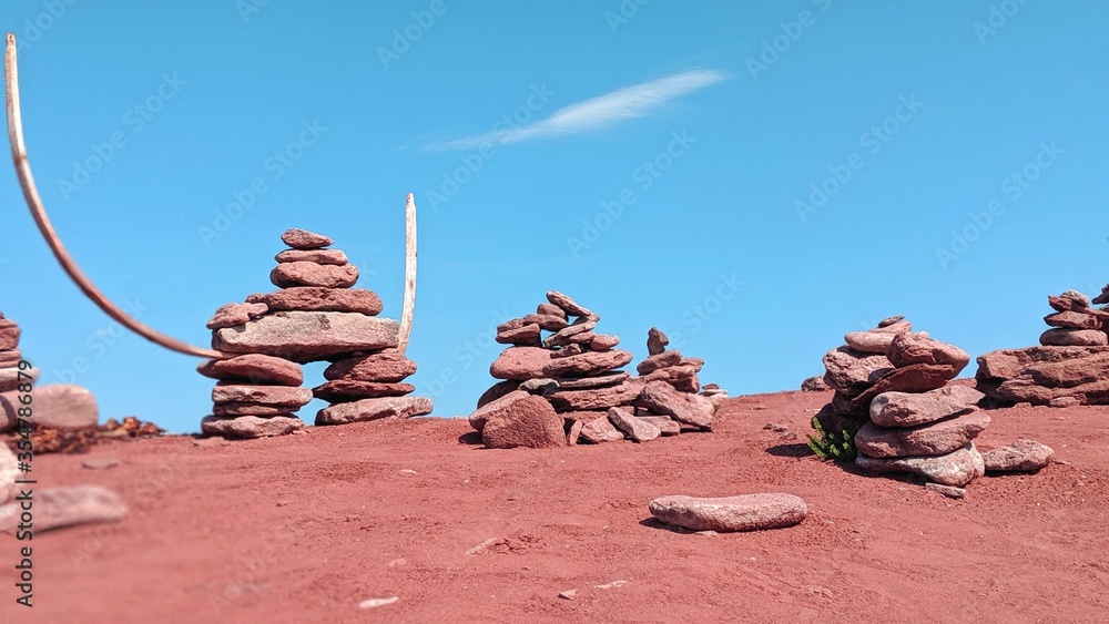Dozens of Inuksuit rock statues cover the red sand beaches of North ...