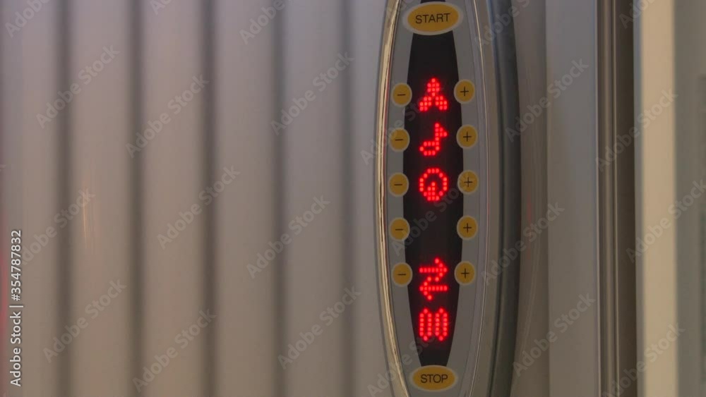 Static shot tanning sun booth LED display with fan icon rotating around ...