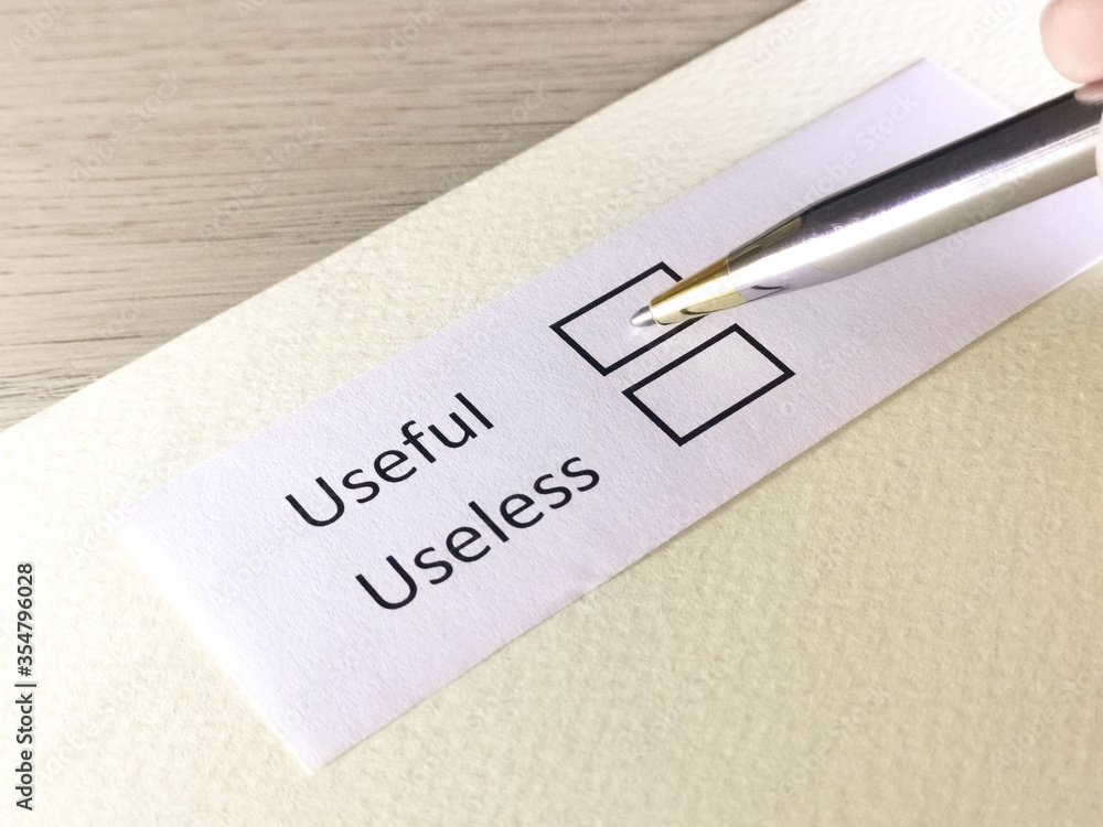 One person is answering question on a piece of paper. The person is ...