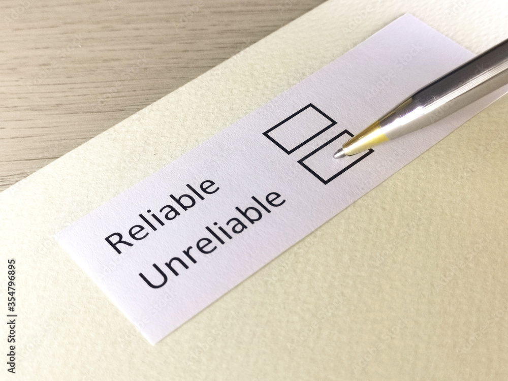 One person is answering question on a piece of paper. The person is ...