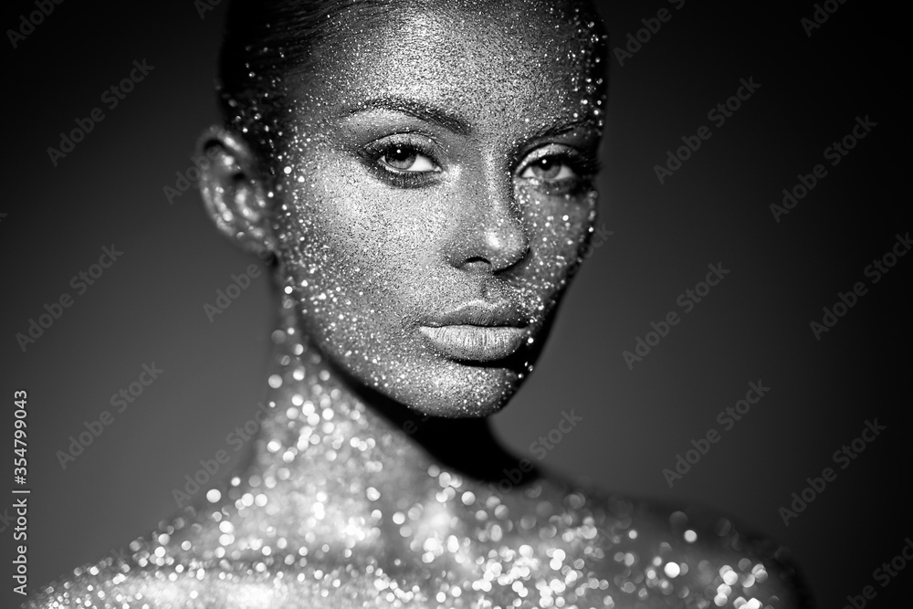 Fashion model woman in bright sparkles and lights posing in studio ...
