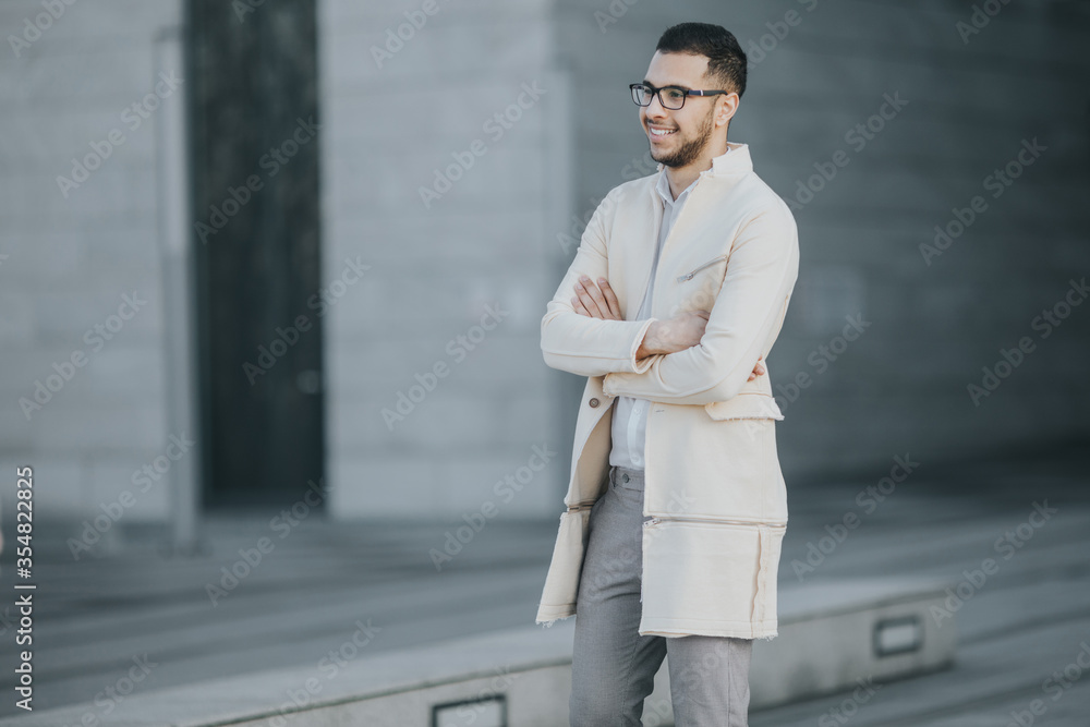 Side view of an intern in a fashion industry standing in front of a ...