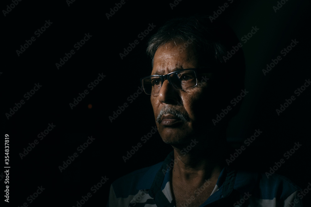 Portrait of a sad Indian Bengali man in light and shadow. Stock Photo ...