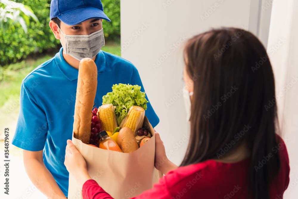 Asian young delivery man in uniform wear protective face mask he making ...