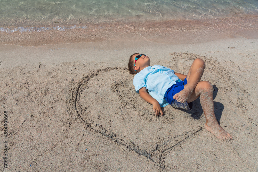White little boy on the pure pink sand beach with magical turquoise ...