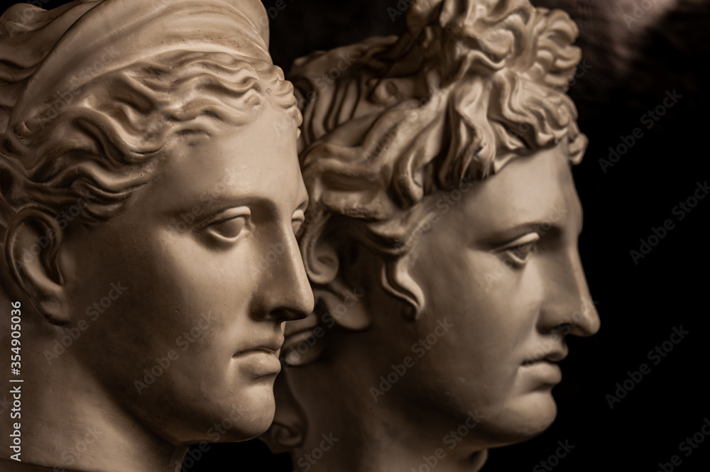 Group gypsum busts of ancient statues human heads for artists on a dark ...