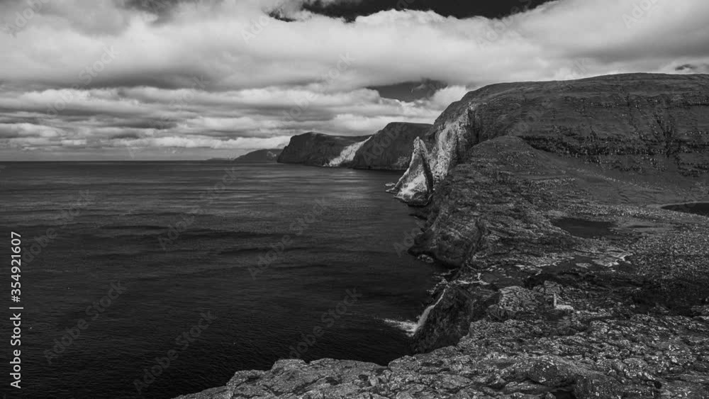 Leitisvatn lake and Bosdalafossur waterfall on Vagar island dramatic B ...