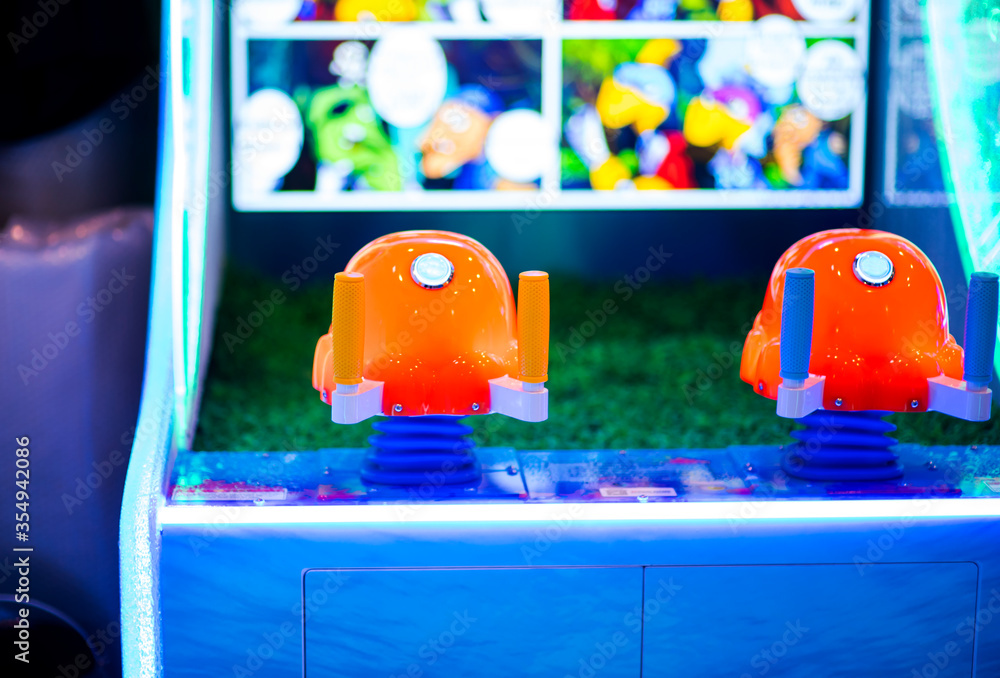 Detail of a joystick and buttons on an old arcade game in a gaming room ...