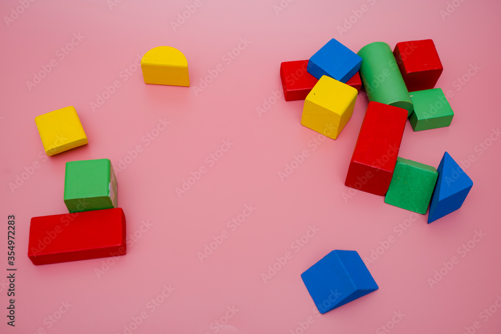 Colorful wooden blocks on pink background. Creativity toys. Children's ...