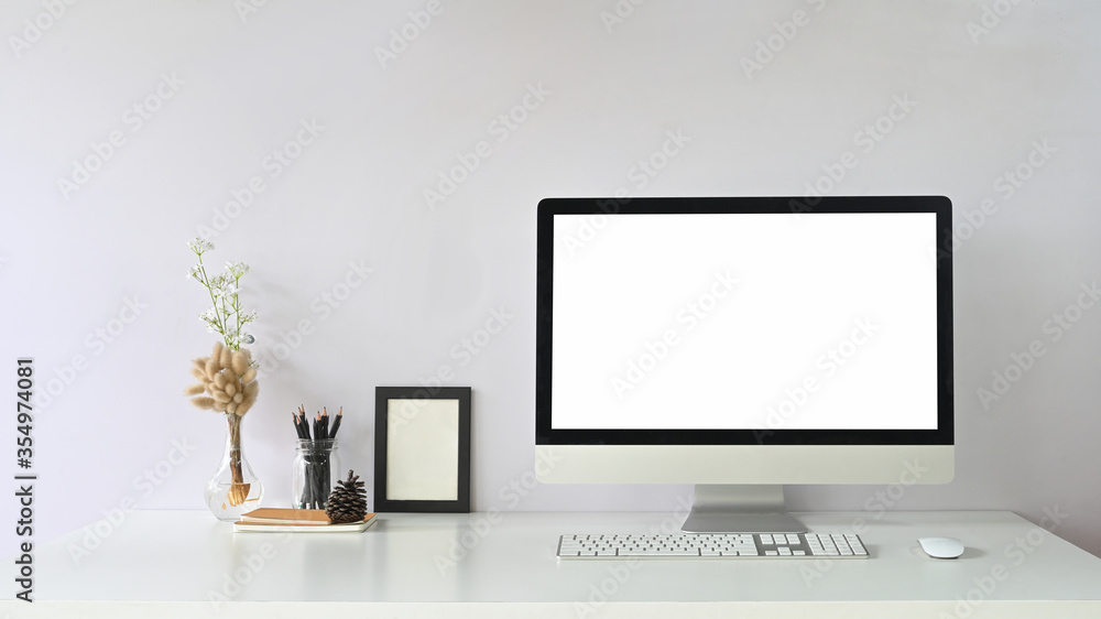 Computer with white blank screen putting on white working desk that ...