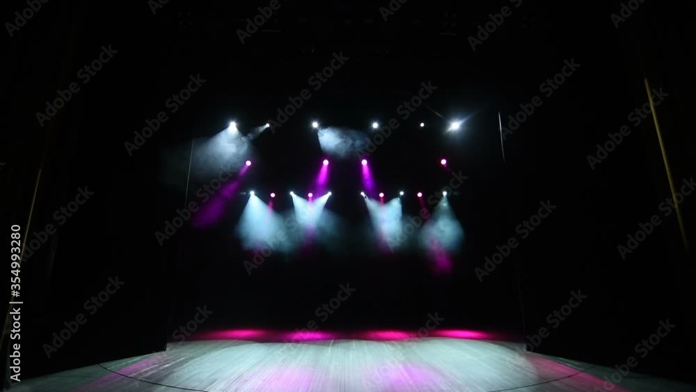 Stage lights flashing at podium. The stage of a theater with pink ...