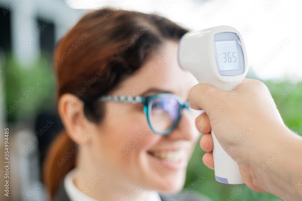 Mandatory measurement of a fever non-contact thermometer gun of all ...