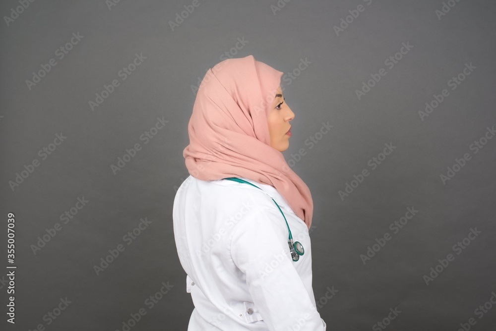 The back side view of a muslim doctor girl wearing medical uniform and ...
