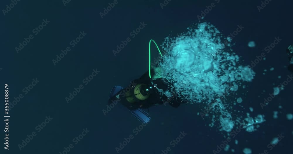 Underwater diver with bubbles in the Ocean. Bubbles float to surface in ...