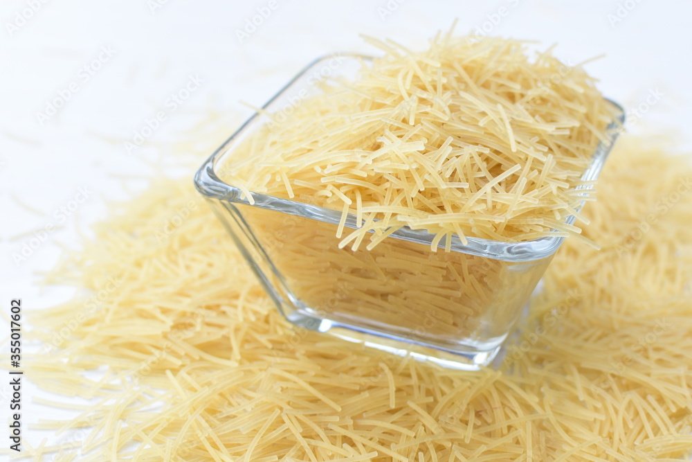 Short pasta spaghetti angel hair displayed in containers on white ...