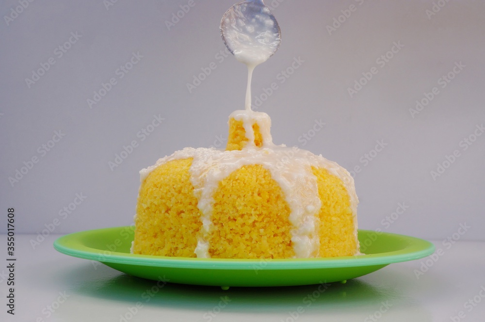 Coconut milk being poured into the Couscous with a spoon. Brazilian ...