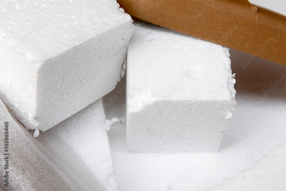 Polystyrene and recycled cardboard stacked ready for garbage collection ...