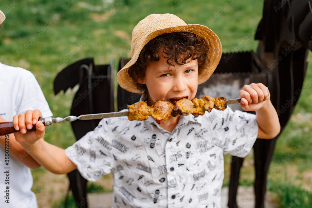 Children getting helpings of food from barbecue grill, Children ...