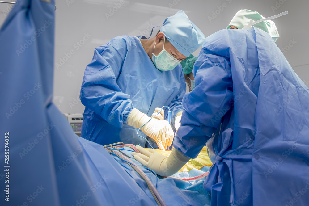 Close up photo of doctor perform surgery inside modern operating room ...