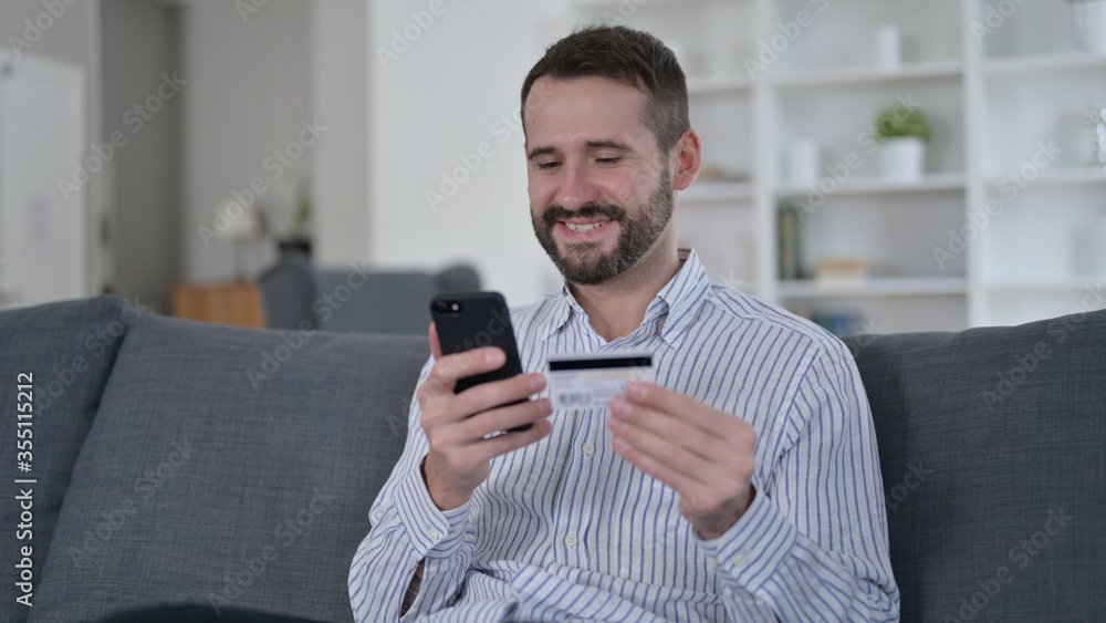 Young Man making Online Payment on Smartphone at Home Stock Photo ...