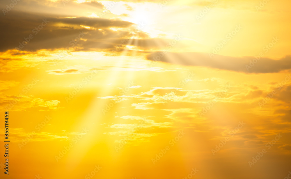 Sunset orange sky with sun rays and yellow clouds Stock Photo | Adobe Stock