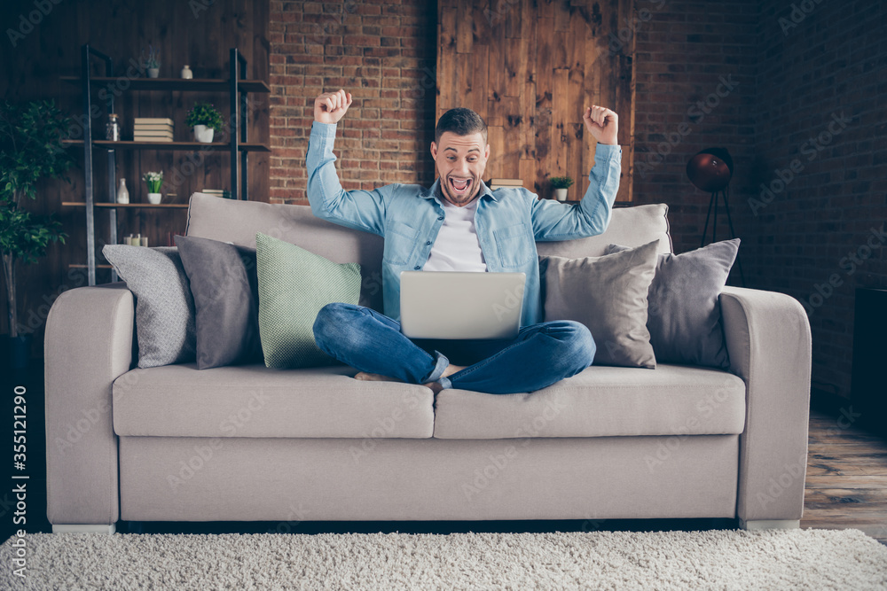 Full body photo of handsome homey guy relaxing sitting comfy couch legs ...