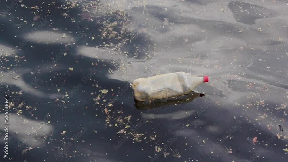 Ecological problem, plastic water bottle floating on water surface ...