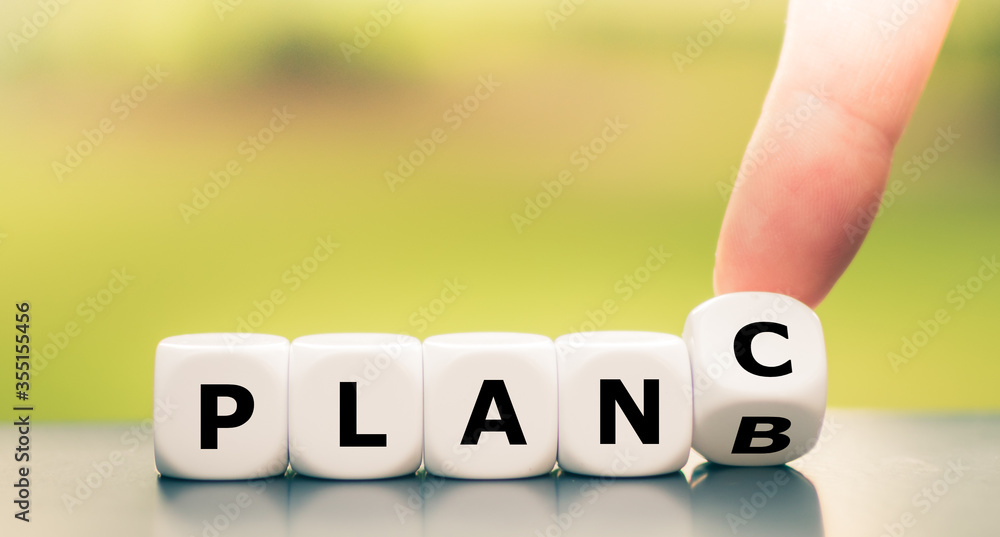 Hand turns dice and changes the expression "plan b" to "plan c". Stock ...