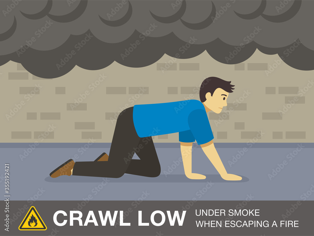 Fire safety activity. Young man crawling to escape a fire in a building ...