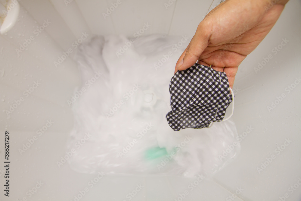 Cleaning a fabric face mask by use a washing machine and powder laundry ...