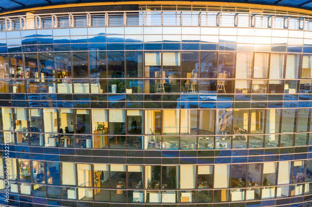 Offices in a modern high rise commercial building with glass facade ...
